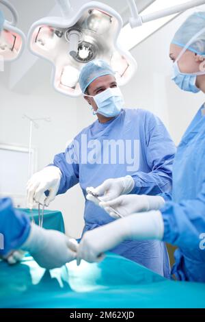 Nurse assisting doctor during surgery Stock Photo - Alamy