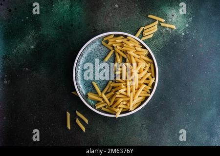 From above uncooked raw penne pasta on the plate Stock Photo - Alamy