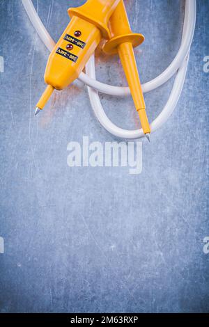 Yellow electrical tester on metallic background Electricity concept ...