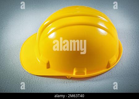 Yellow safety cap on concrete background top view Stock Photo - Alamy
