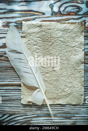 Old paper sheet plume wooden hearts on vintage wood board celebrations ...