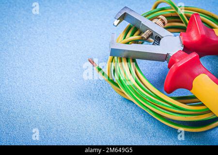 Wire stripper pliers electric cables on blue background electricity ...