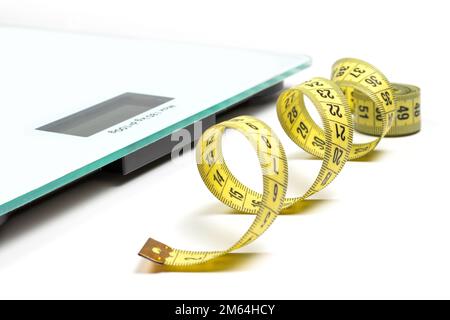 Modern scales and tape measure isolated on white, top view Stock Photo ...