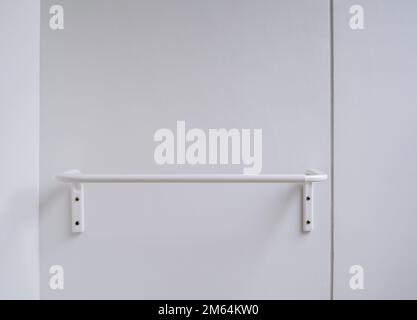 Modern drying rack with clothes on white background Stock Photo - Alamy