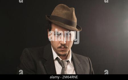 Old school mobster in a retro hat Stock Photo - Alamy