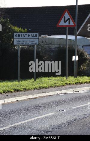 Road leading into the Lincolnshire village of Heckington, cars are ...