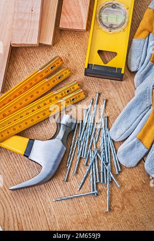 gloves hammer level nails planks on wooden board Stock Photo - Alamy