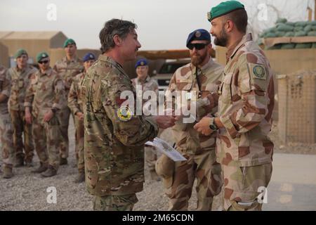 A Norwegian officer presents the Norwegian Ruck March pin and ...