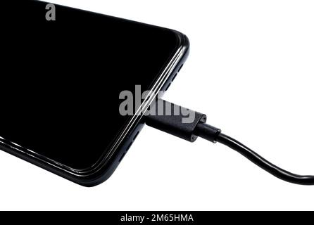 Smartphone charging via usb cable on a white background. Wired charging ...