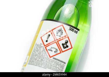 Hazard warning label on bottle of bleach sodium hypochlorite hydroxide ...