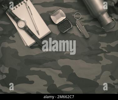 Military themed overhead shot of personal items laid out on a ...