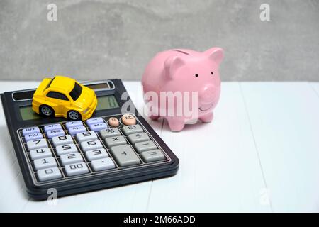 Piggy bank, calculator and car, concept spending and accumulating ...