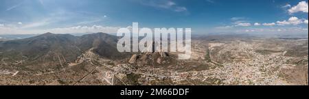 Panoramic view of Peña de Bernal, at the foot of the mountain the ...