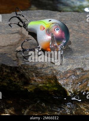 Water all around a rock and artificial fishing bait Stock Photo - Alamy