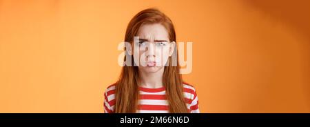 Childish offended cute redhead girl pouting, sulking upset, frowning ...