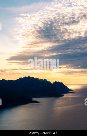 Landscape of sunrise over Mount Segla and mountaineer walking with snow ...