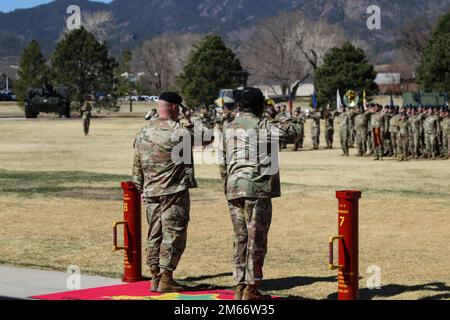 Col. Damon Wells, commander of 4th Infantry Division Artillery, hands over the battalion colors ...