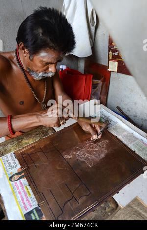 A craftsman working in his workshop in the grounds of the Meenakshi ...
