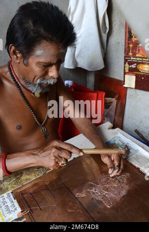 A craftsman working in his workshop in the grounds of the Meenakshi ...