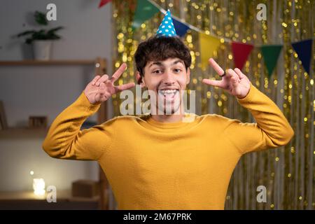 Portrait of optimistic funny guy showing paper heart wear pink cap t ...