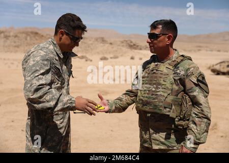 1st Cavalry Division Trooper presents flowers to Shari Rhoades, wife of ...