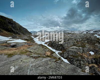 An aerial shot of snowy dry scenery on the road 520 between Sauda and ...