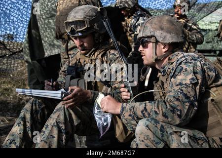 U.S. Marines with 3rd Battalion, 12th Marines attach an M777 Howitzer ...