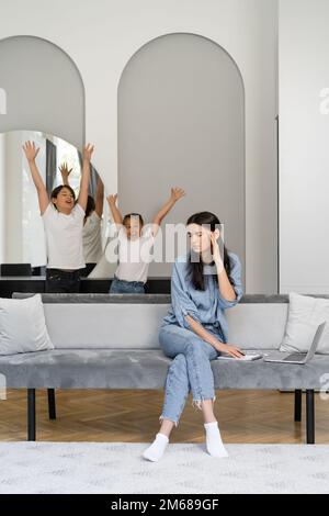 Tired exhausted Asian girl freelancer sleeping while working from home ...