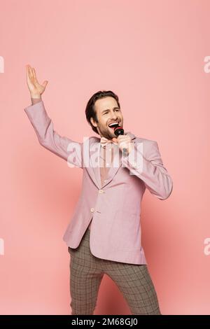 cheerful event host man singing with microphone. merry christmas. event ...