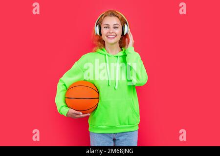 glad redhead basketball woman player on color background. basketball ...