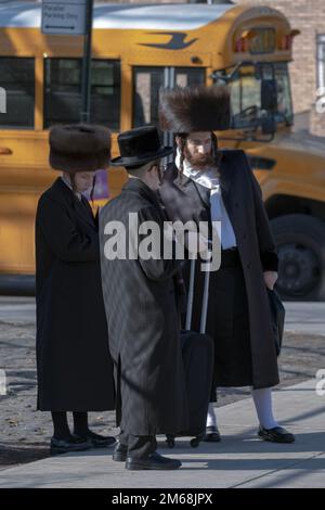 On a Friday afternoon, a Hasidic family waits for a bus to take them ...