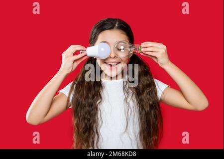 teen girl with lightbulb on background. photo of teen girl with ...