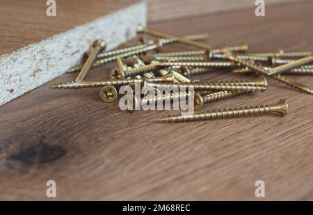 wood screws on melamine manufactured wood panel Stock Photo - Alamy