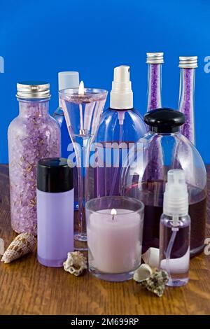 Spa products. Lavender bath salts with flowers and towel. Violet purple ...