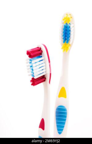 Red, yellow, blue and green toothbrushes with multicolored paper sticky ...