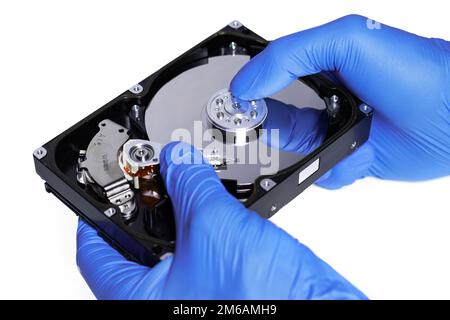 Repair Hard disk. Hands of master in gloves repair the computer hard ...