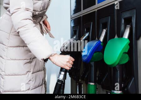 Woman pumping gasoline fuel in car at gas station. Petrol or gasoline ...