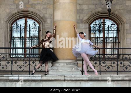 Two beautiful ballerinas dancing together around a column Stock Photo ...
