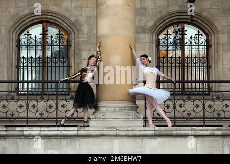 Two beautiful ballerinas dancing together around a column Stock Photo ...