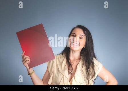 Portrait of professional female lawyer showing flyer from her office ...