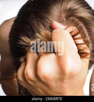 Closeup of hand pulling hair from head of a male person Stock Photo - Alamy