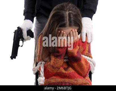 Terrorist with gun and scared little hostage on white background Stock ...