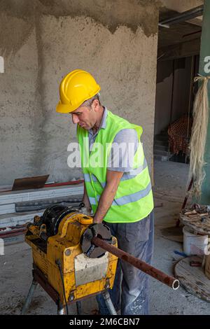 Technician is grooving steel pipe. Iron pipe master working iron pipes ...