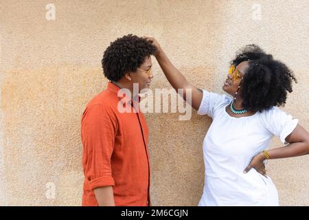 Woman caressing her boyfriend in public park Stock Photo - Alamy