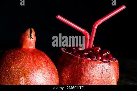 ripe garnet with drinking straw on a rustic wooden background Stock ...