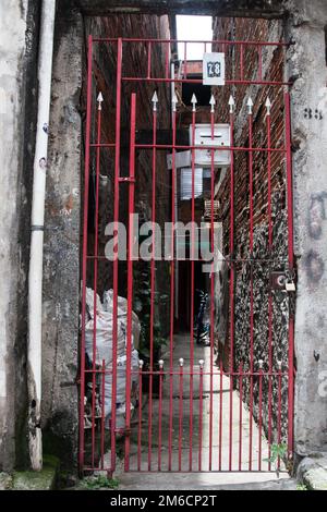 Red metal gate of a favela in Brazil Stock Photo - Alamy