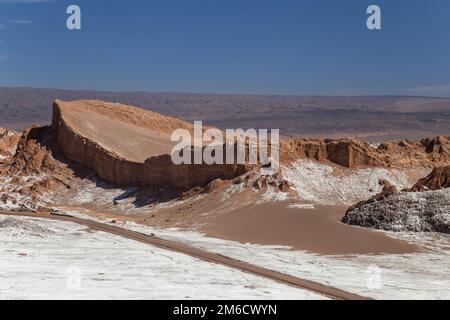 Dunes and rock formations covered with dry salt in Valle de la Luna ...