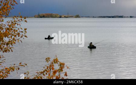 Fishing in deep blue water lake Stock Photo - Alamy