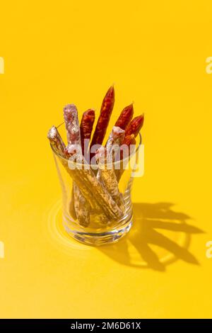 Flat lay of Spanish mini chorizo on yellow Stock Photo - Alamy