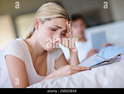 Young worried couple looking at touchpad display while surfing in the ...